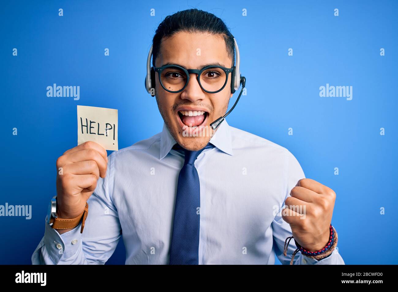 Young brazilian call center agent man overworked holding reminder paper ...