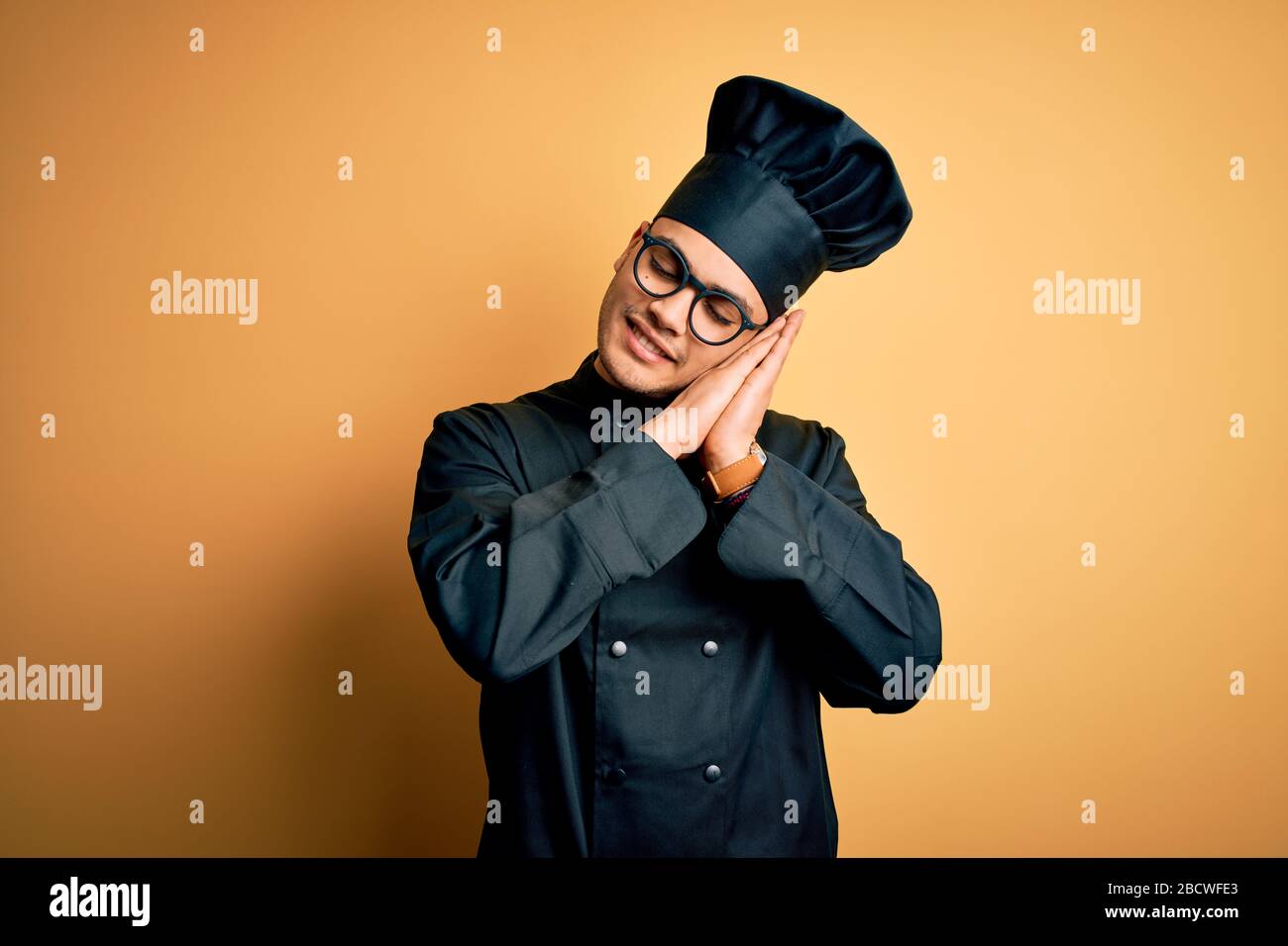 Young brazilian chef man wearing cooker uniform and hat over isolated ...