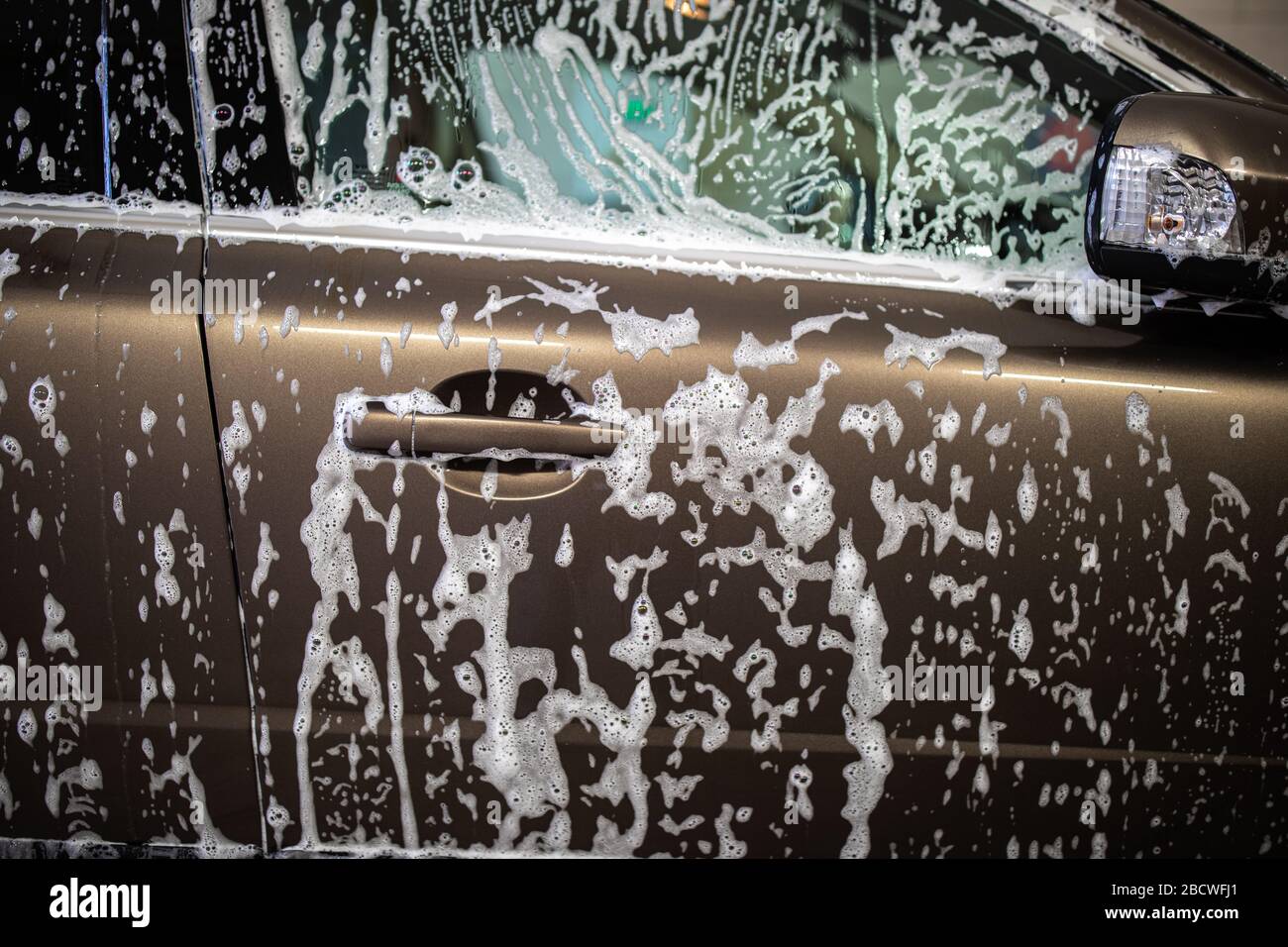 Car in a carwash covered with shampoo Stock Photo - Alamy