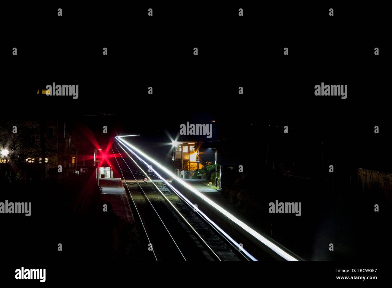 Light trails from a Northern rail train passing the signal box and ...