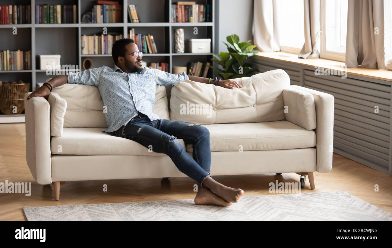 African man sit on couch hi-res stock photography and images - Alamy