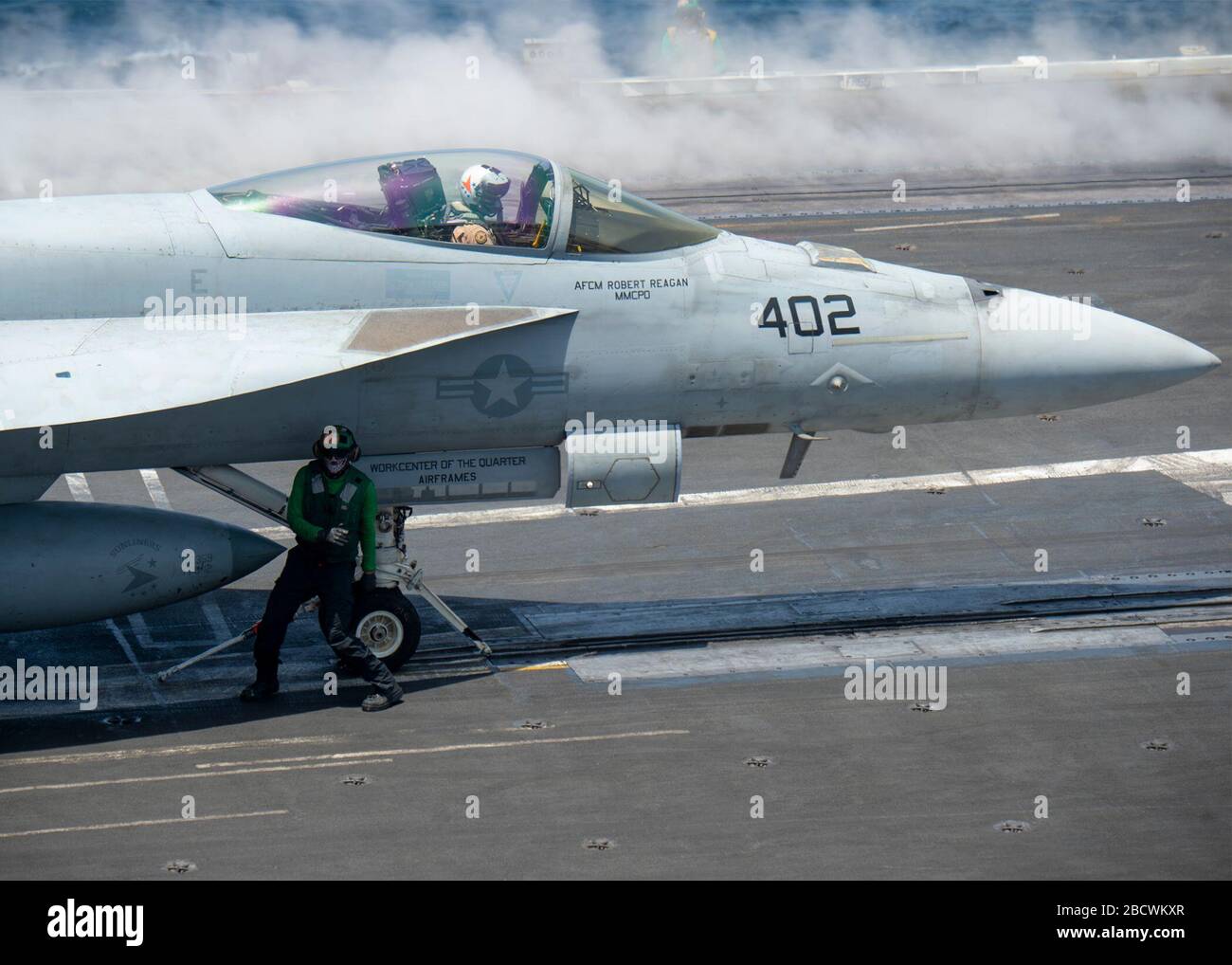 A U.S. Navy F/A-18E Super Hornet fighter aircraft attached to the ...