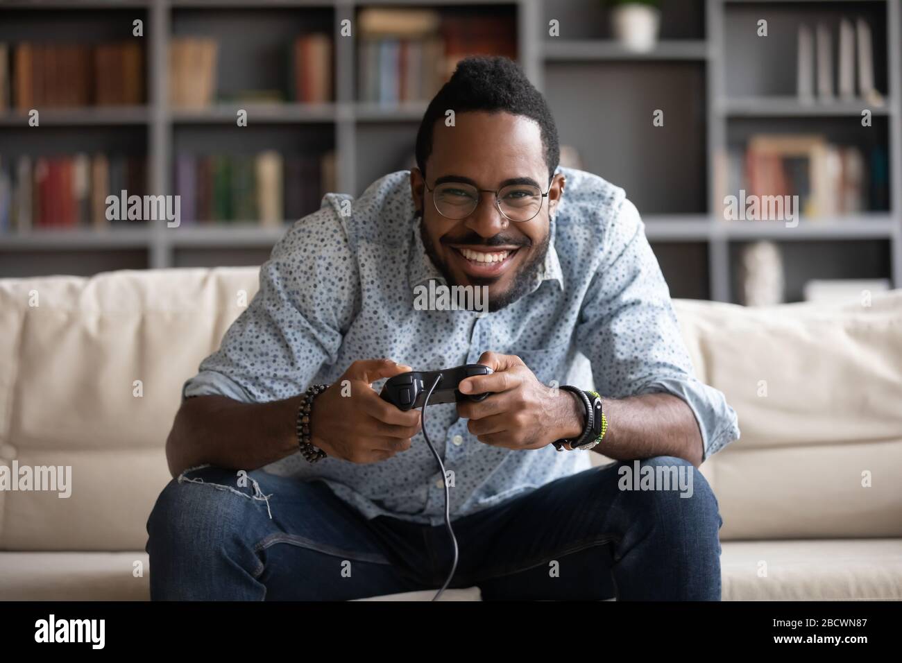 Happy african American man play video game Stock Photo - Alamy