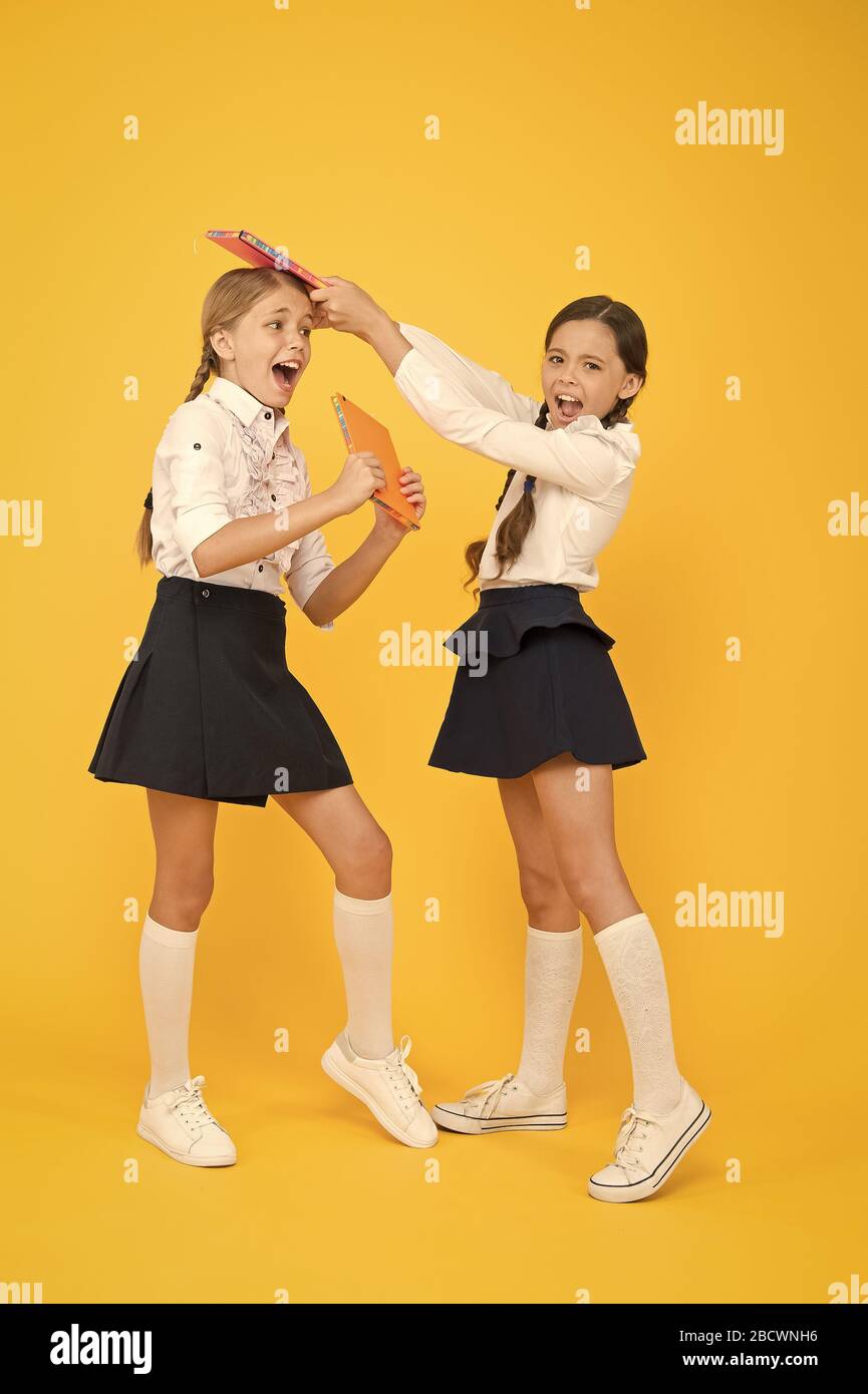 schoolgirls fight. outraged classmates with workbook. girls can't share ...