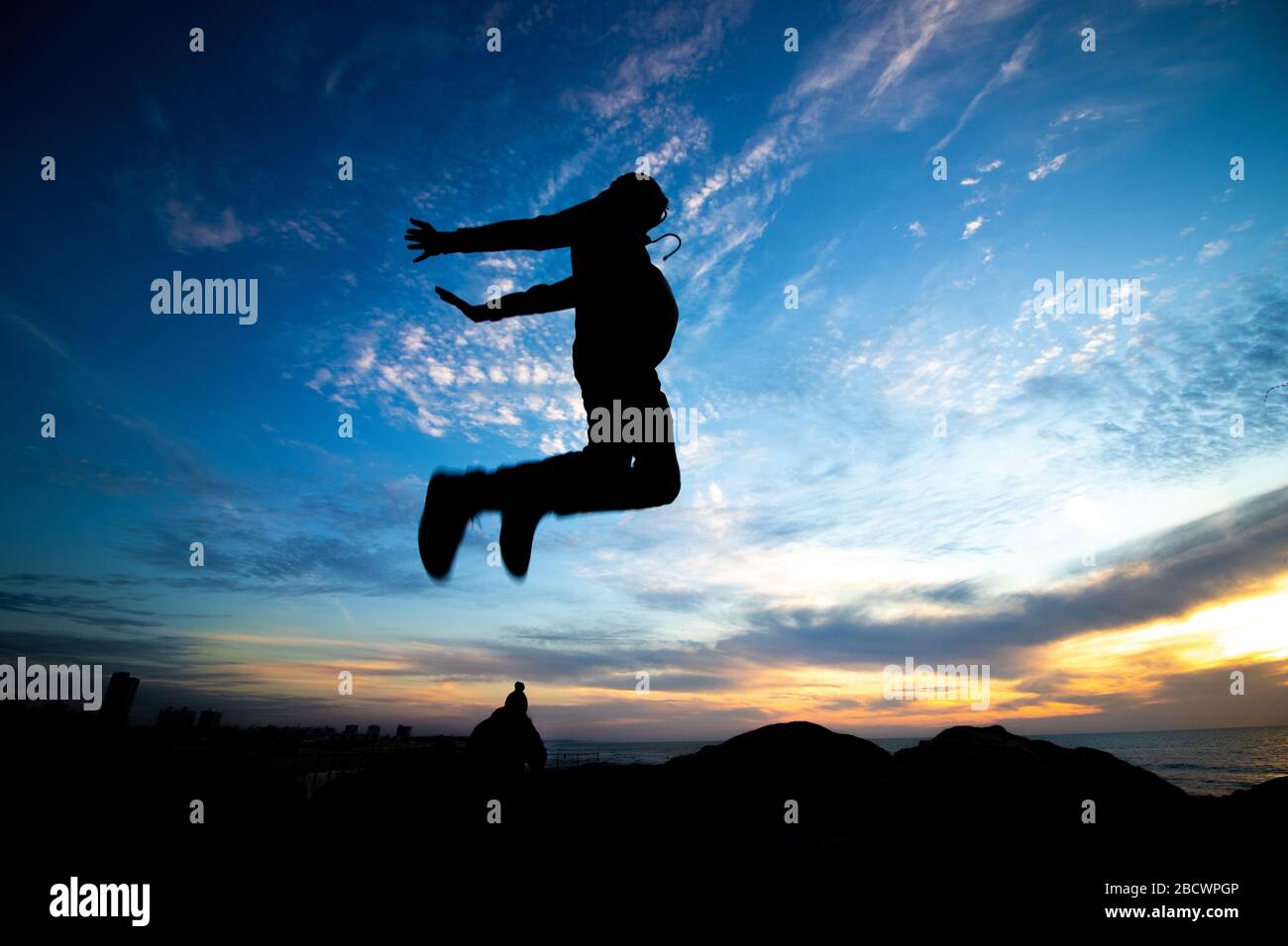 Child jumping against blue sky hi-res stock photography and images - Alamy