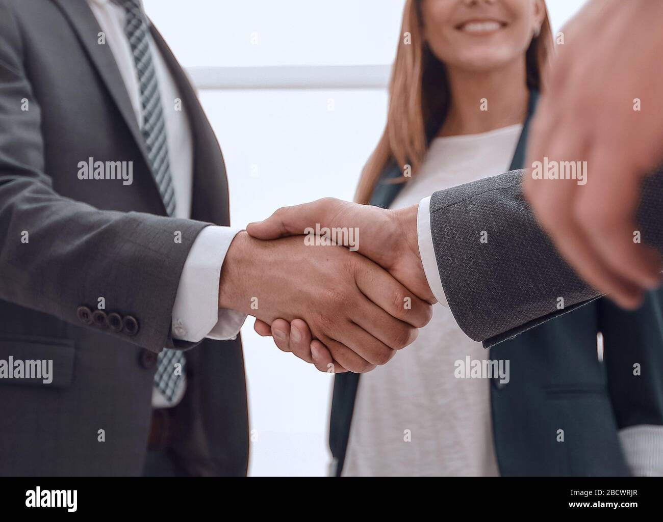 Business shaking hands in the office Stock Photo - Alamy