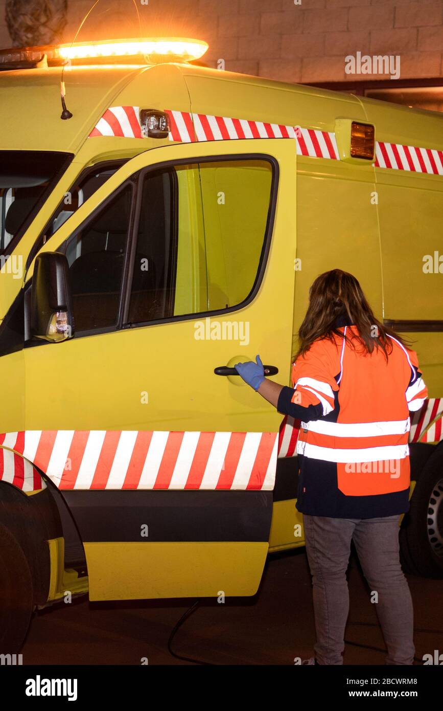 Night scene of an unrecognizable Paramedic, Ambulance woman driver at ...