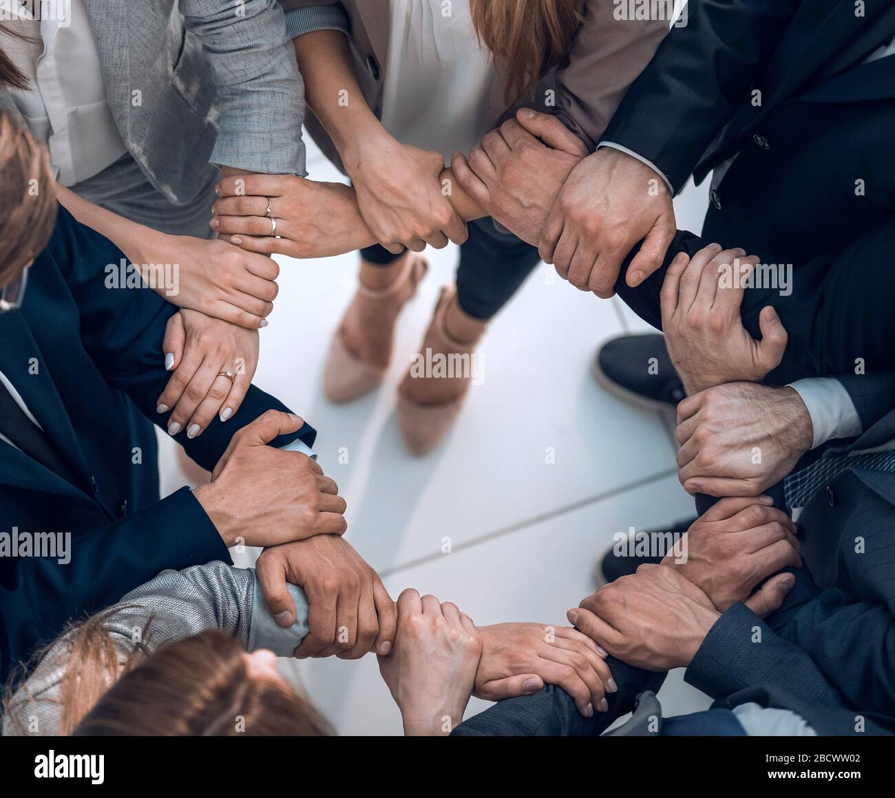 group of employees forming a circle out of hands Stock Photo - Alamy