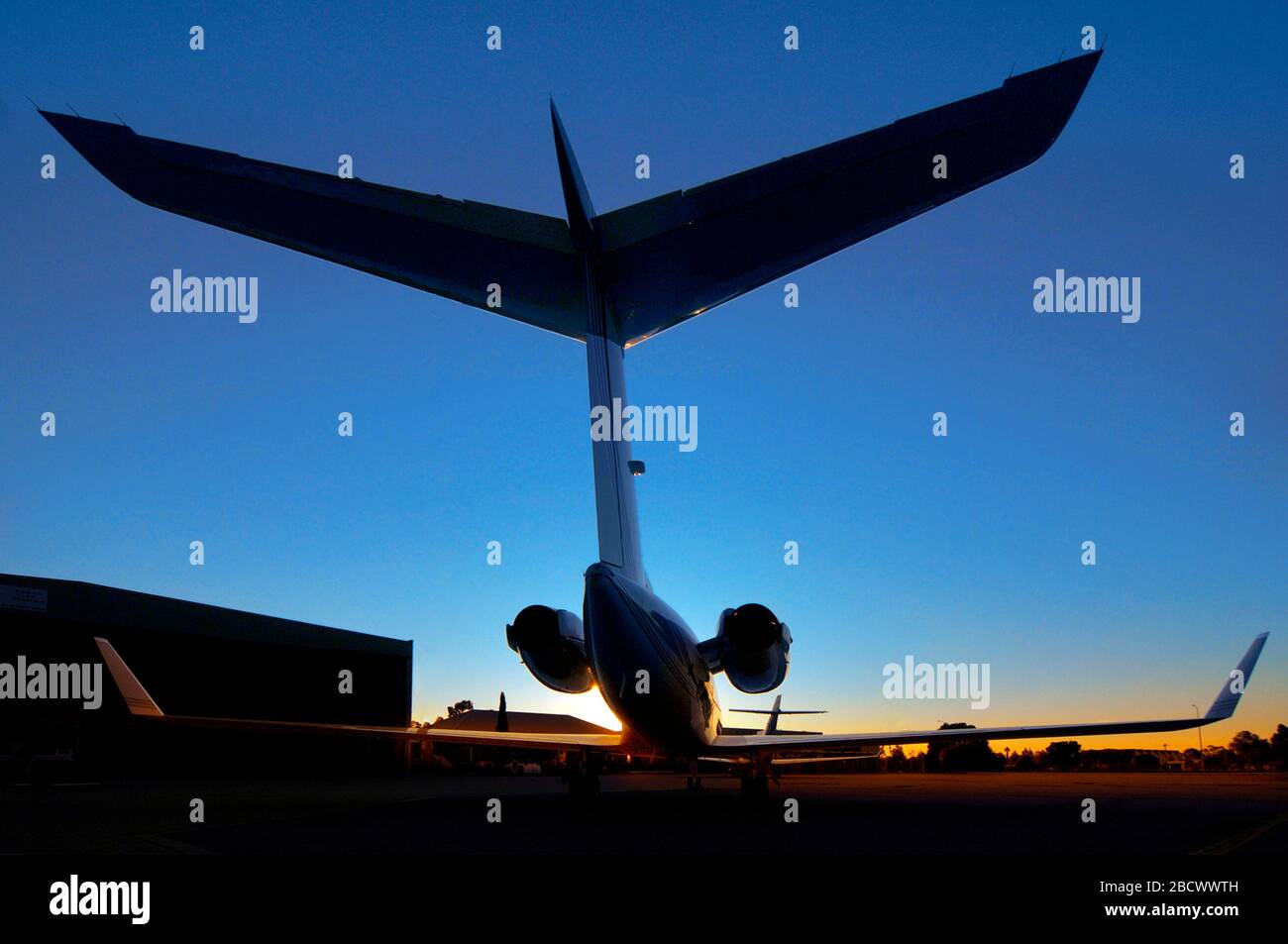 Moody silhouetted rear end viewpoint image of a Bombardier Challenger ...