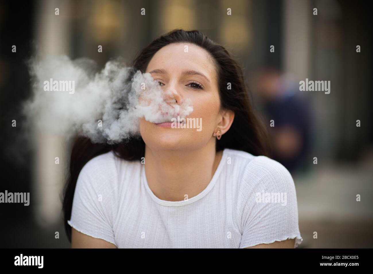 a young woman vaping Stock Photo - Alamy