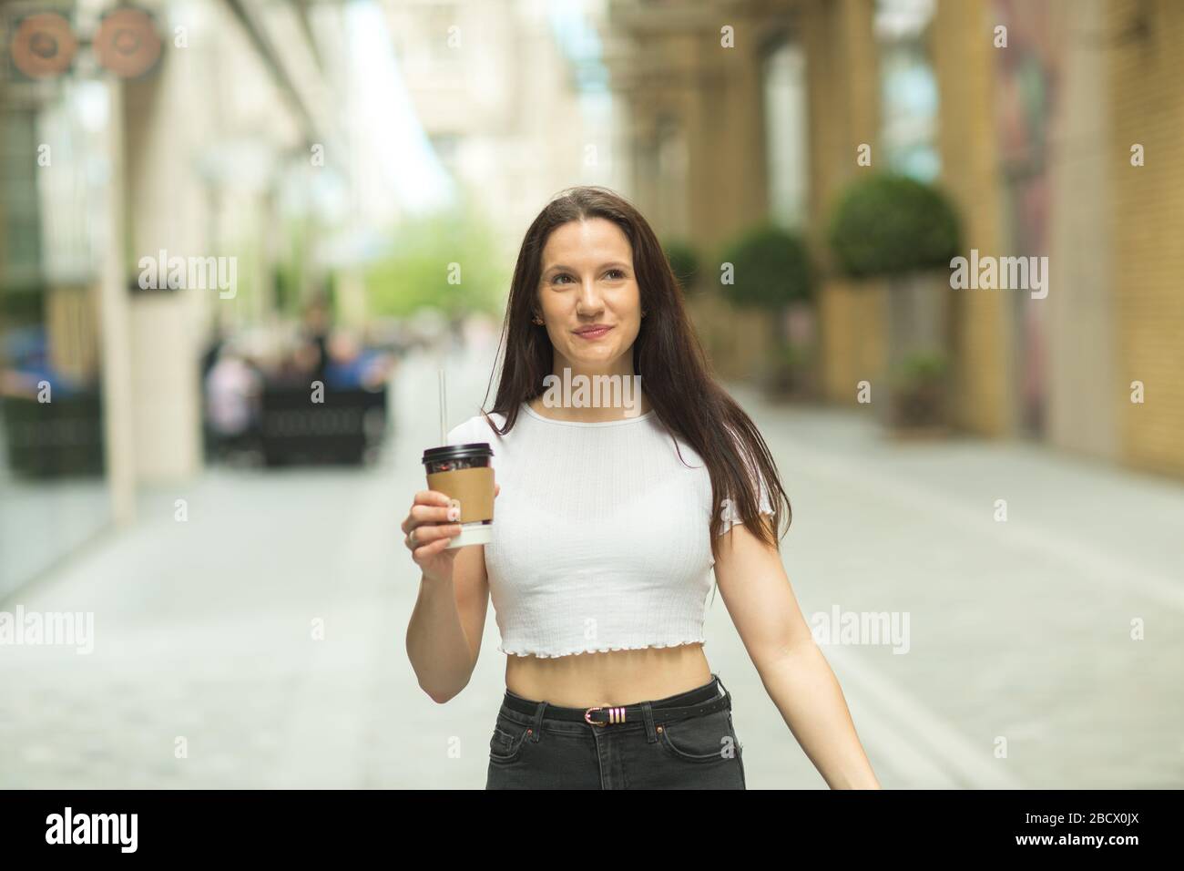 Beautiful woman walking drinking tea hi-res stock photography and ...