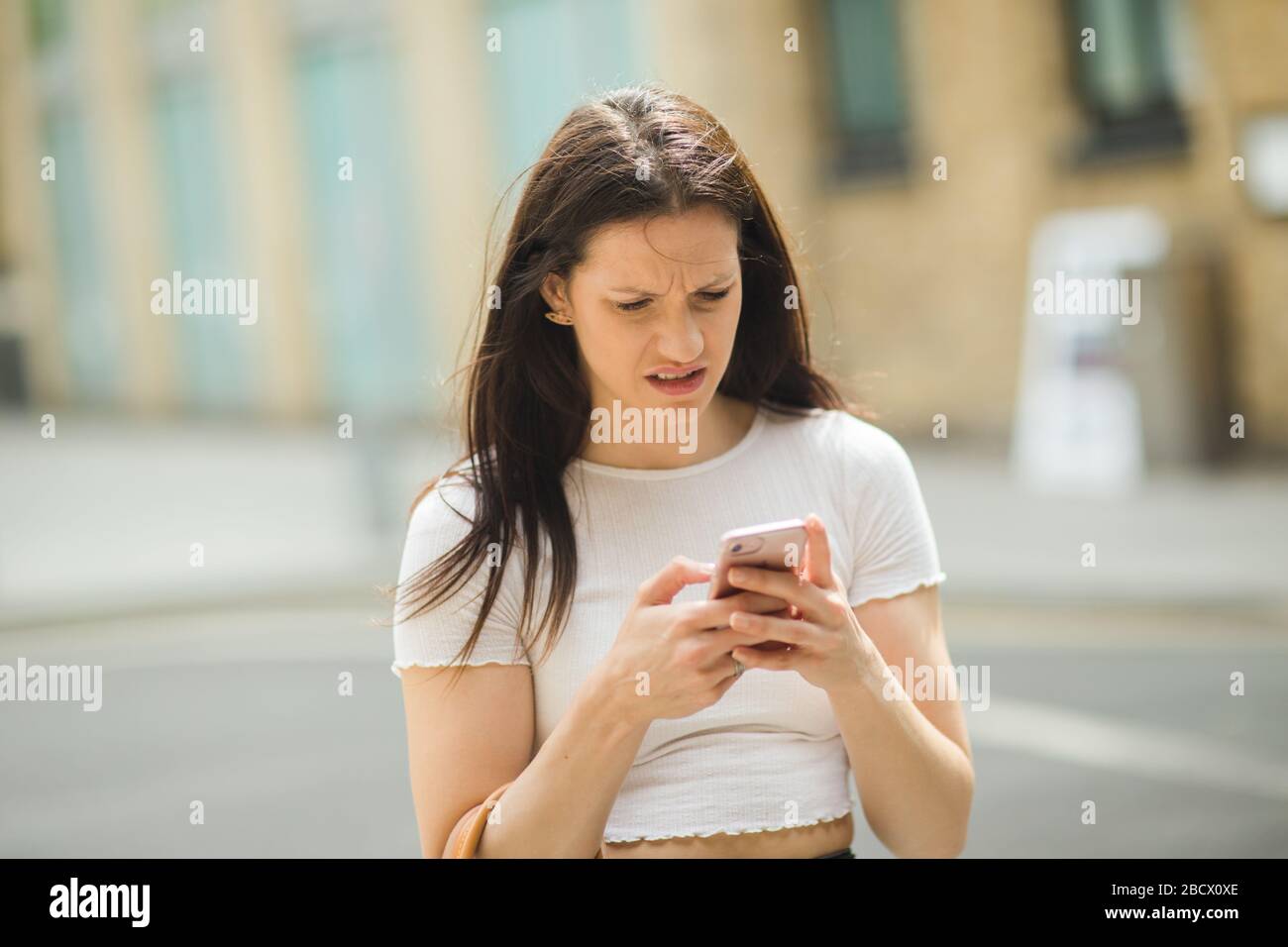 young woman reading a text message Stock Photo - Alamy