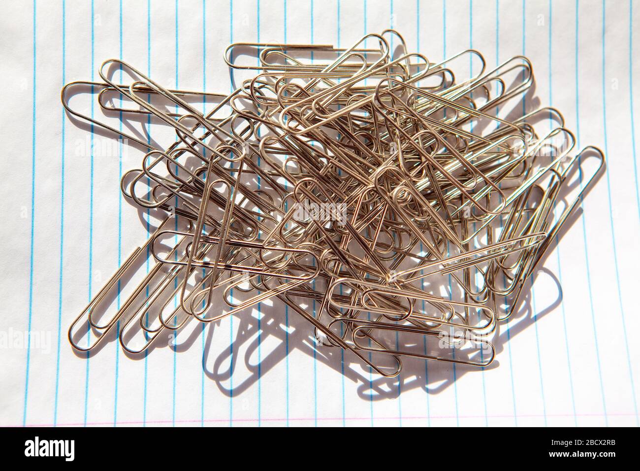 pile of paper clips on white background Stock Photo - Alamy
