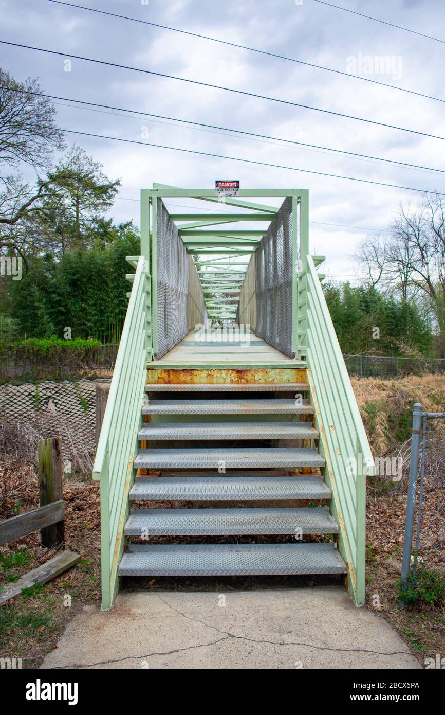 A Steel Mint Colored Foot Bridge to Cross Train Tracks Below Stock ...