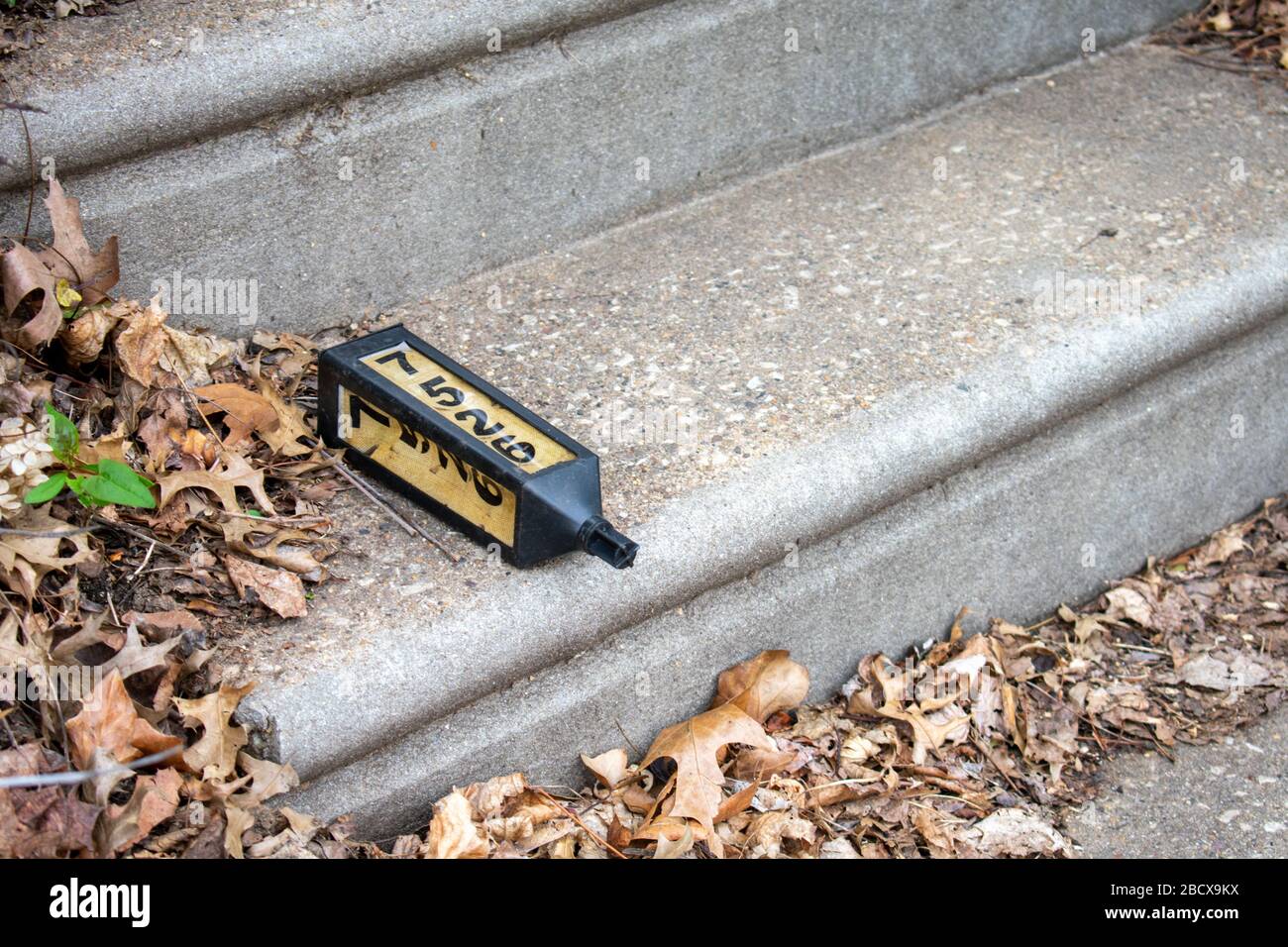 A Broken Address Sign Light on a Concrete Step Stock Photo - Alamy