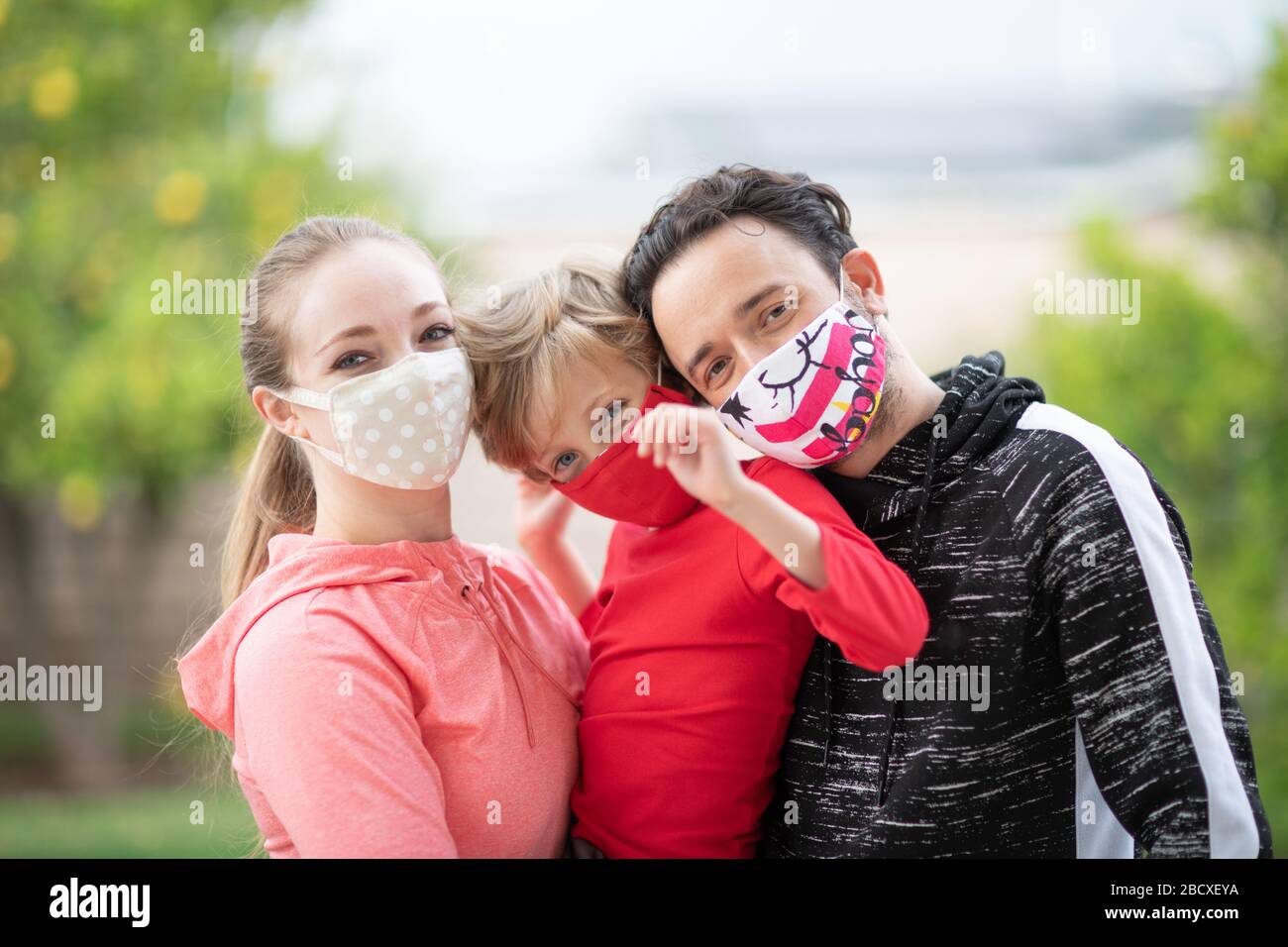 Family members embracing each other, smiling in the camera wearing ...