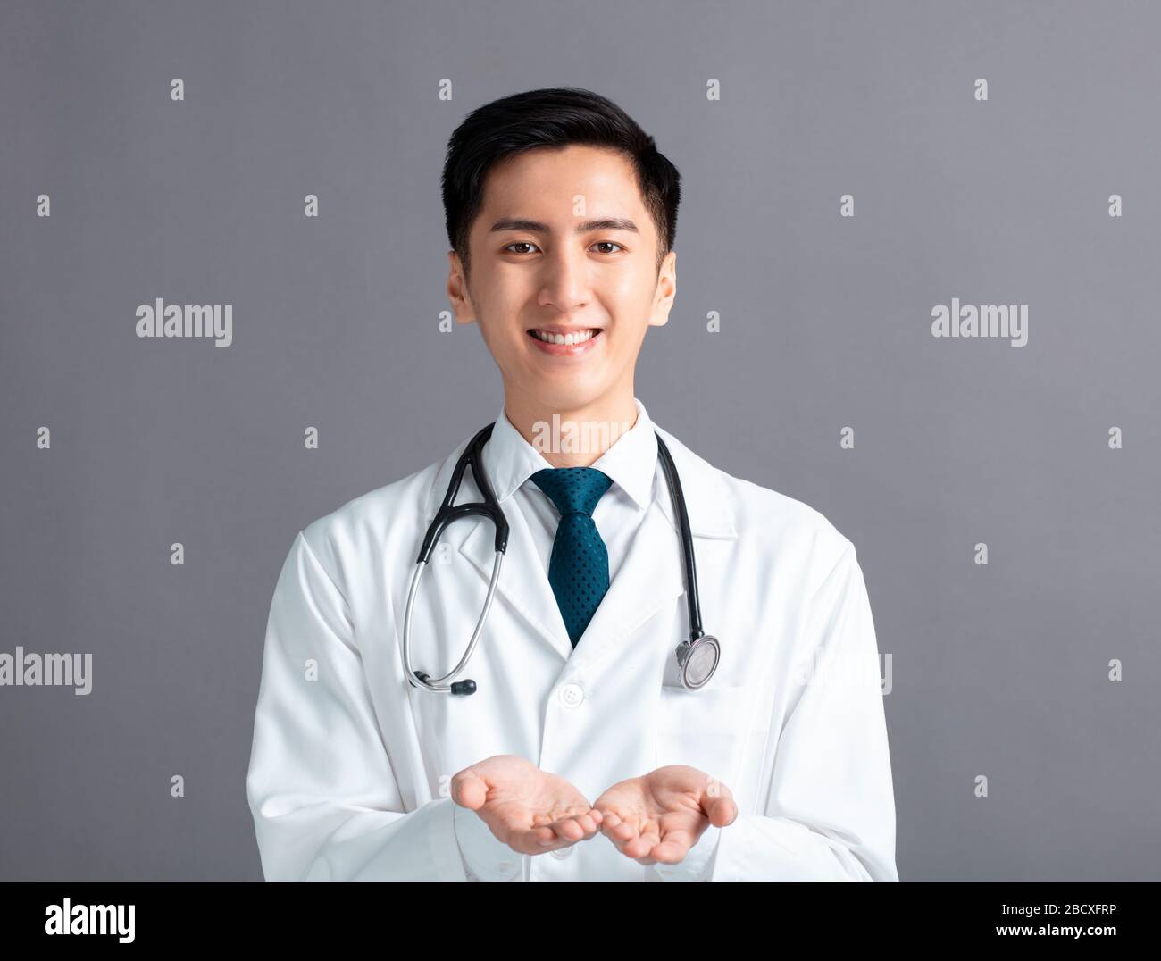 Handsome man doctor showing something hi-res stock photography and ...
