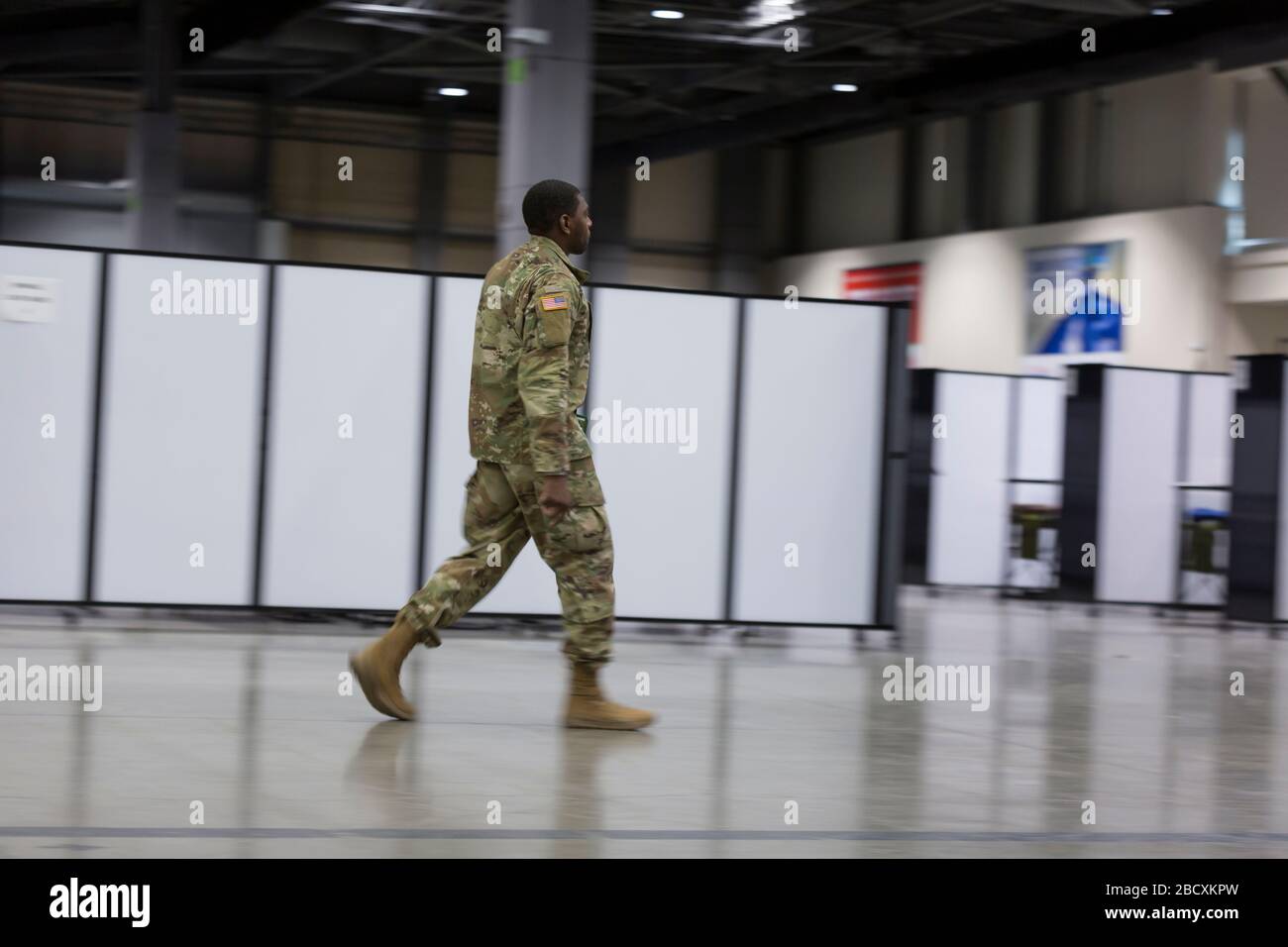 A soldier walks past the completed ICU units at the field hospital in ...