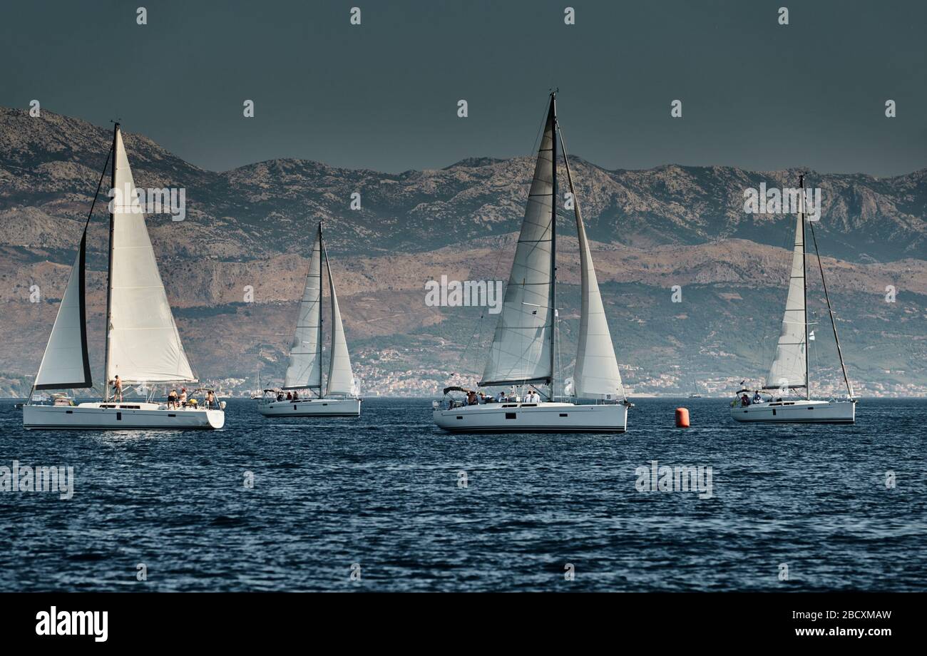 The race of sailboats, a regatta, reflection of sails on water, Intense ...