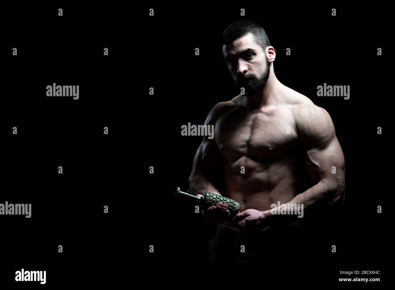 Man With a Bomb in His Hand on Black Background Stock Photo - Alamy