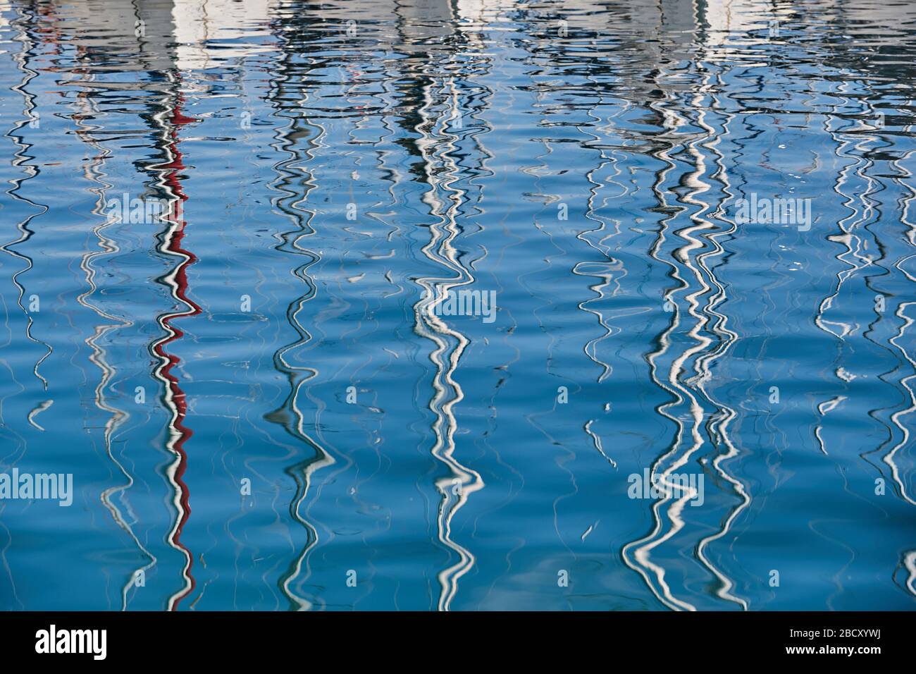 Reflection of masts of sailboats on water, interesting texture, smooth ...