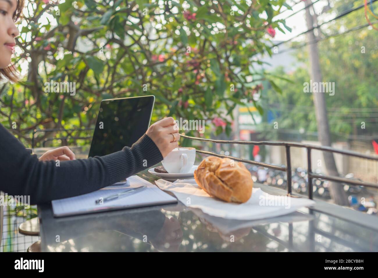 Young woman working from home balcony hi-res stock photography and ...