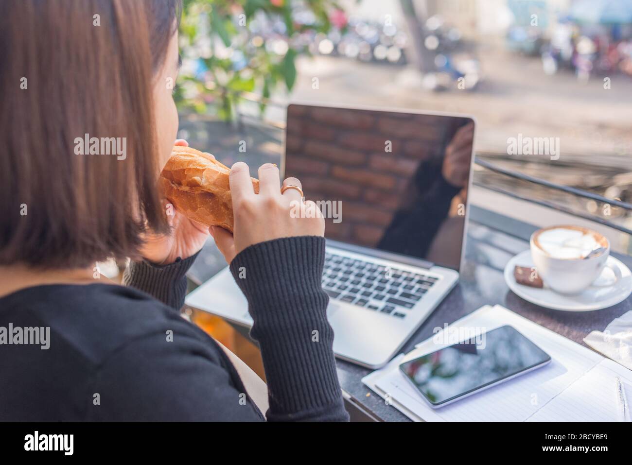 Young woman working from home balcony hi-res stock photography and ...