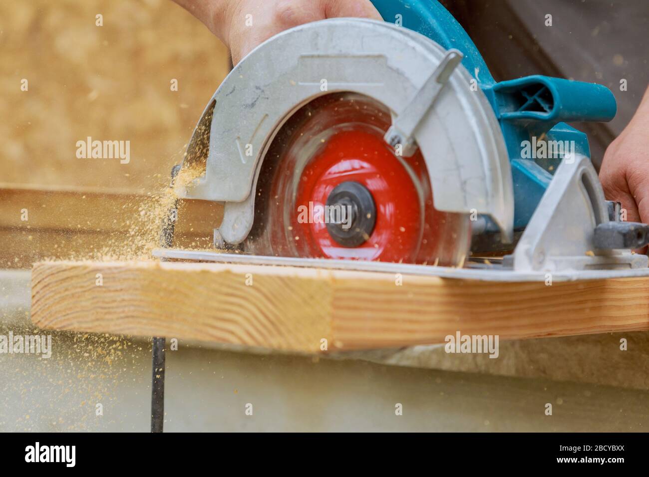 Man cutting wood using an electrical chain saw professional tools Stock ...