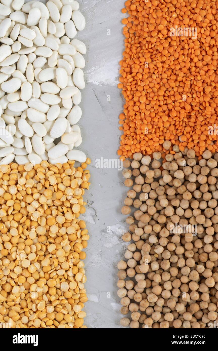 healthy food rows of beans and lentils on stone table, flat lay ...