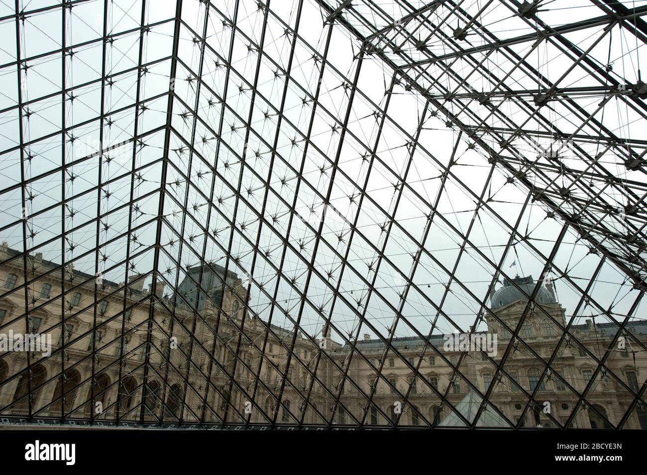 Louvre Museum buildings through pyramid window, Paris, France Stock ...