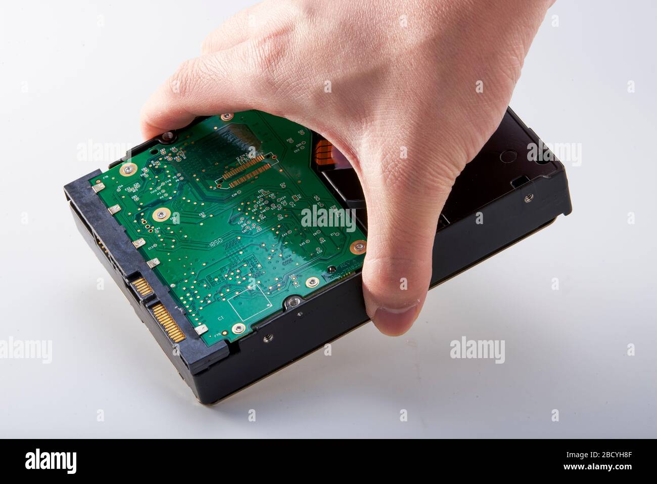 Pick up a 3.5-inch computer mechanical hard drive with one hand Stock ...