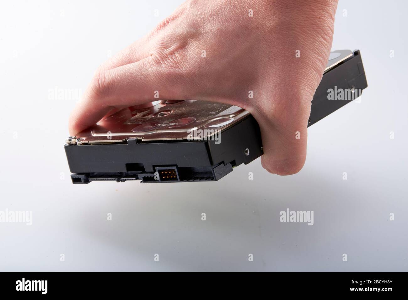 Pick up a 3.5-inch computer mechanical hard drive with one hand Stock ...