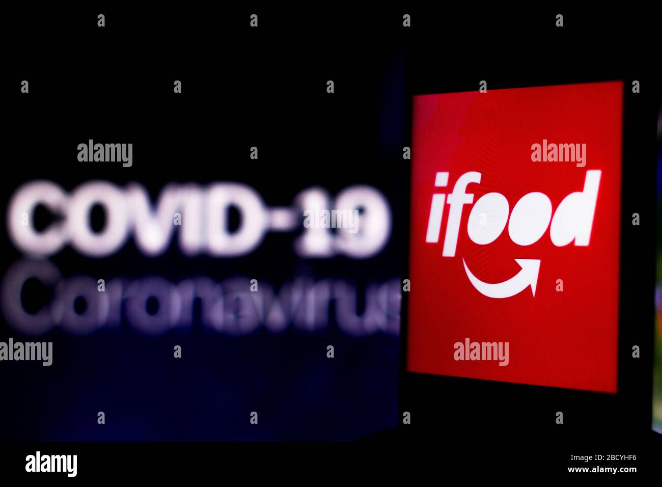 In this photo illustration the iFood logo seen displayed on a ...