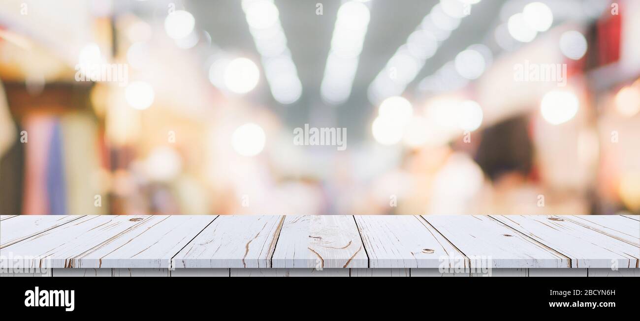 Abstract blurred image of department store with wooden table counter ...
