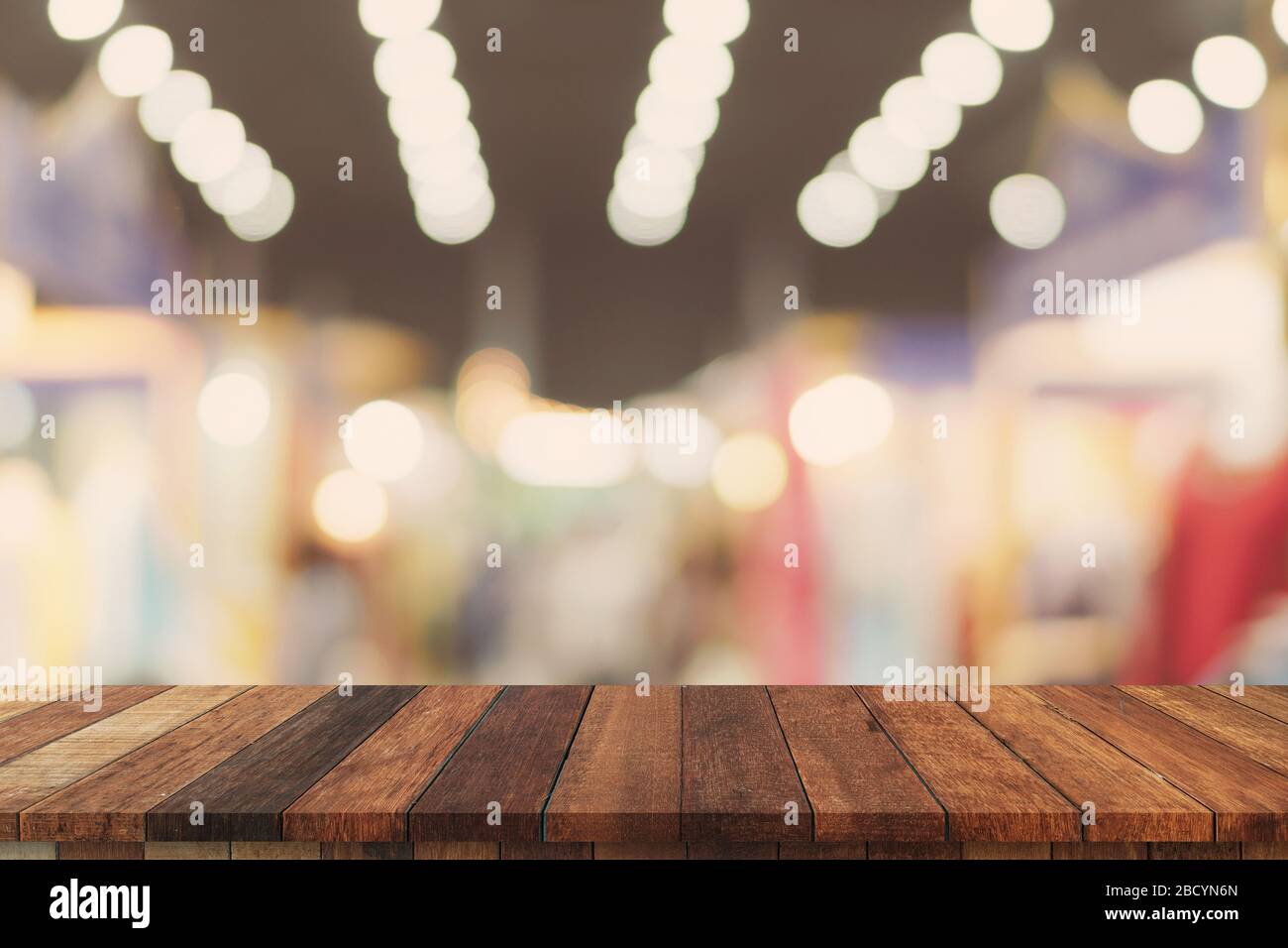 Abstract blurred image of department store with wooden table counter ...