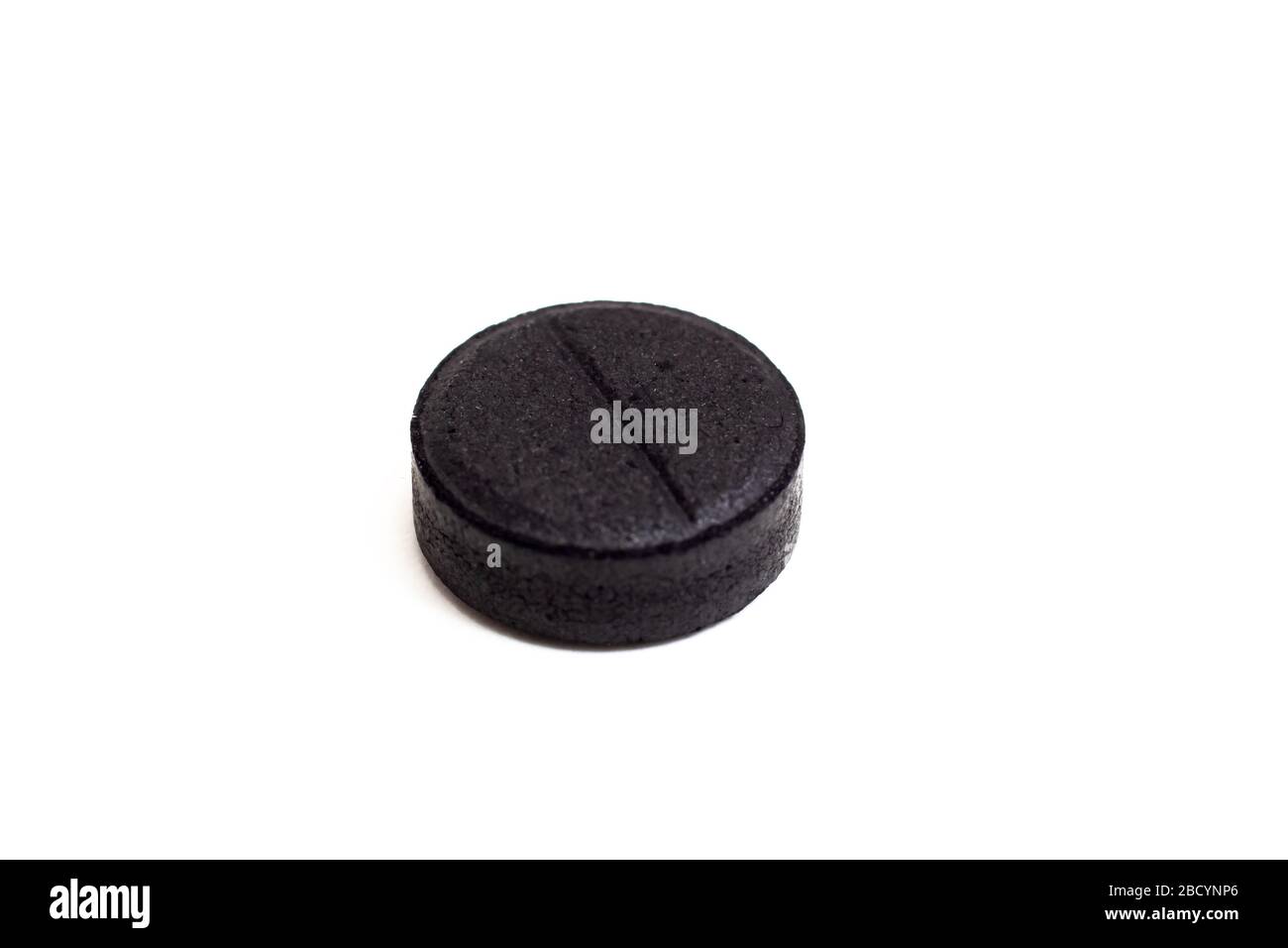 One black charcoal tablet isolated on a white background close up Stock ...