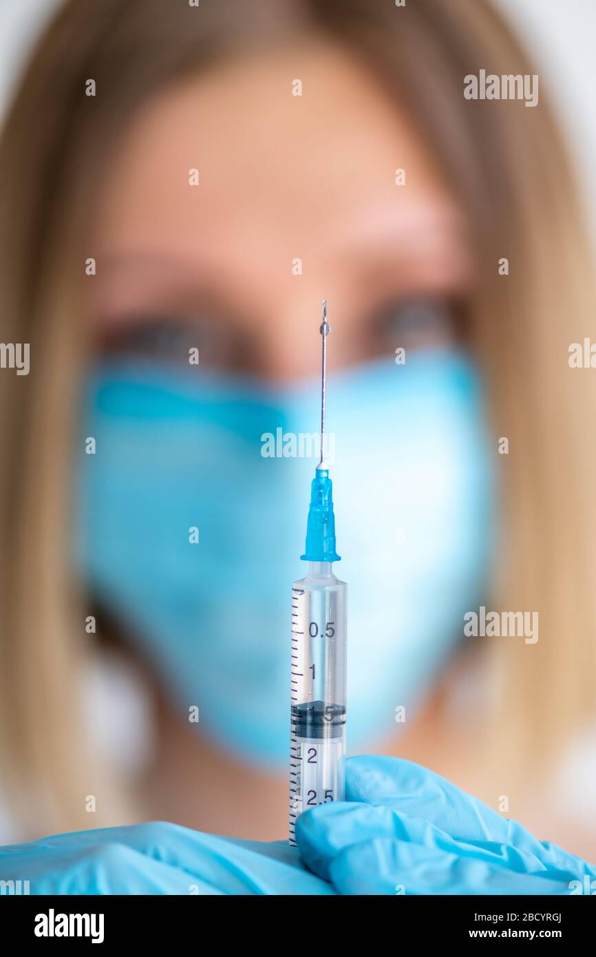 Syringe for injection in nurse hand. Medical glass vial for vaccination ...