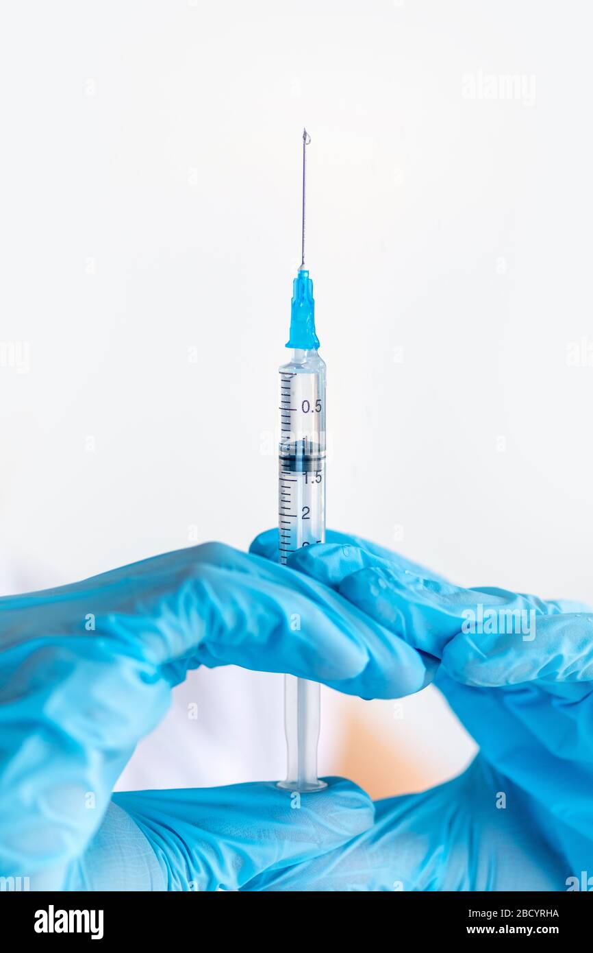 Syringe for injection in nurse hand. Medical glass vial for vaccination ...