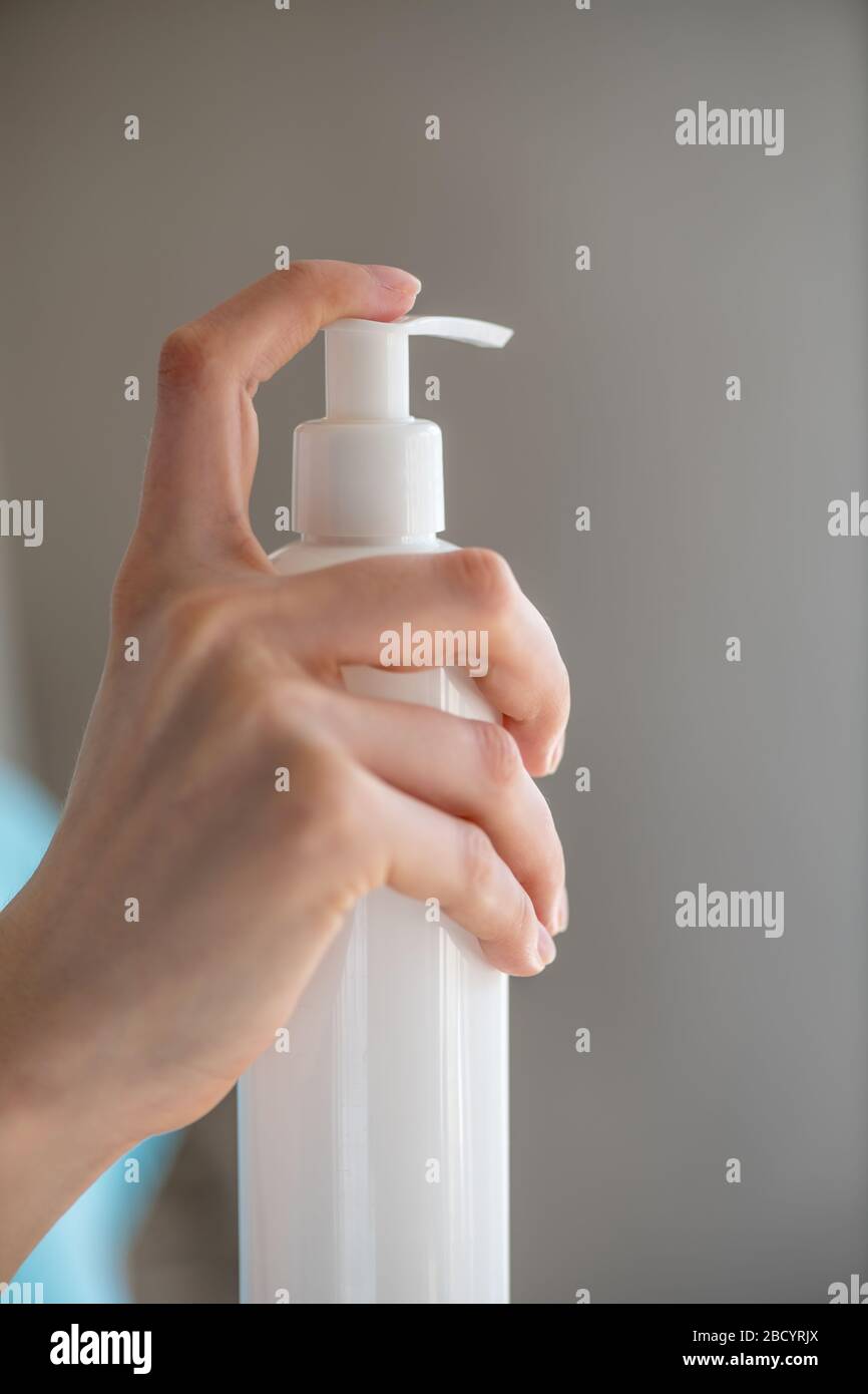 Female person woman or girl applying soap disinfectant product on hand ...