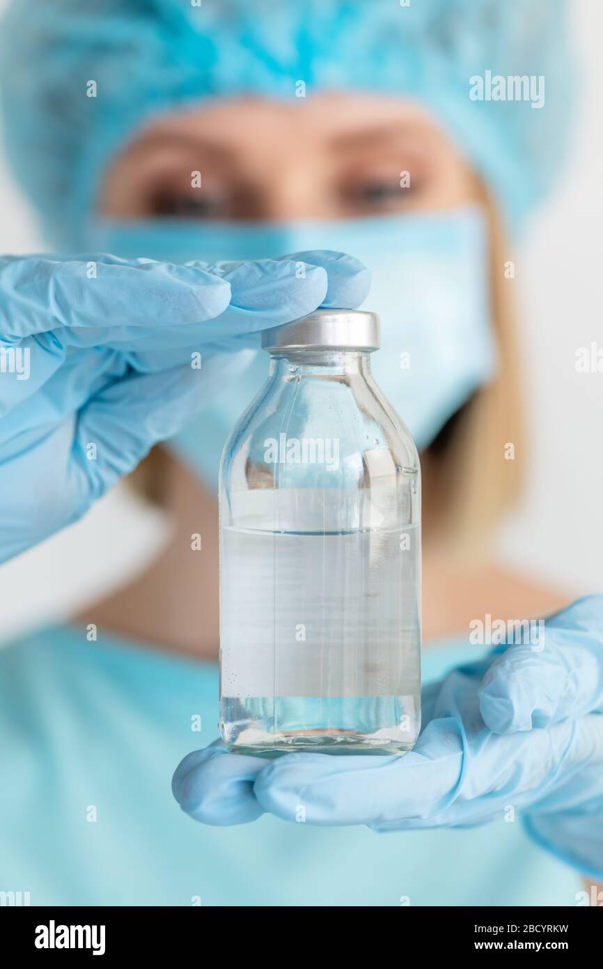 Bottle for injection in nurse hand. Medical glass vial for vaccination ...