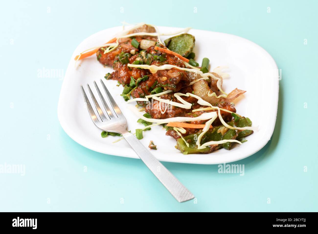 chilli paneer or Spicy cottage cheese, Garnish with capsicum, onion ...