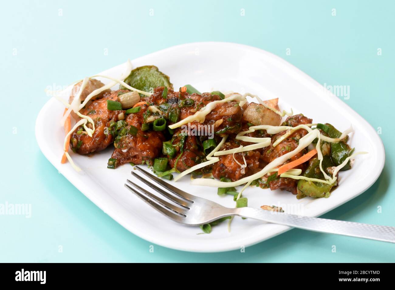 chilli paneer or Spicy cottage cheese, Garnish with capsicum, onion ...