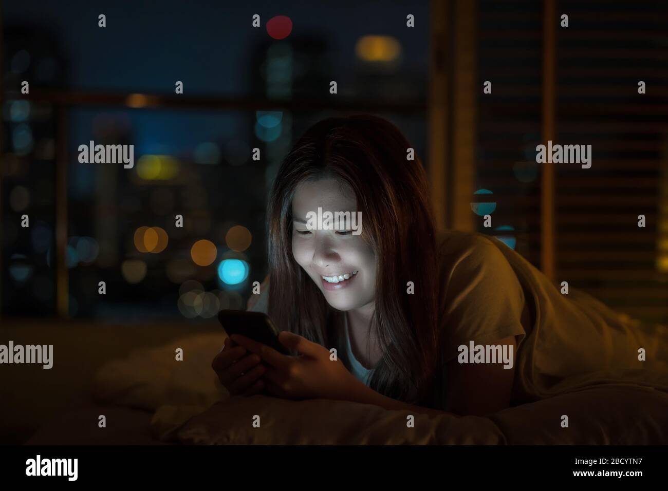 Closeup Asian woman sleeping and using smart mobile phone for social ...