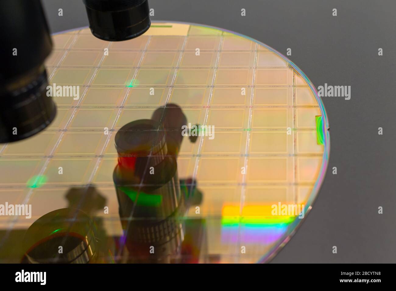 Close up of silicon wafer with microchips on machine process examining ...