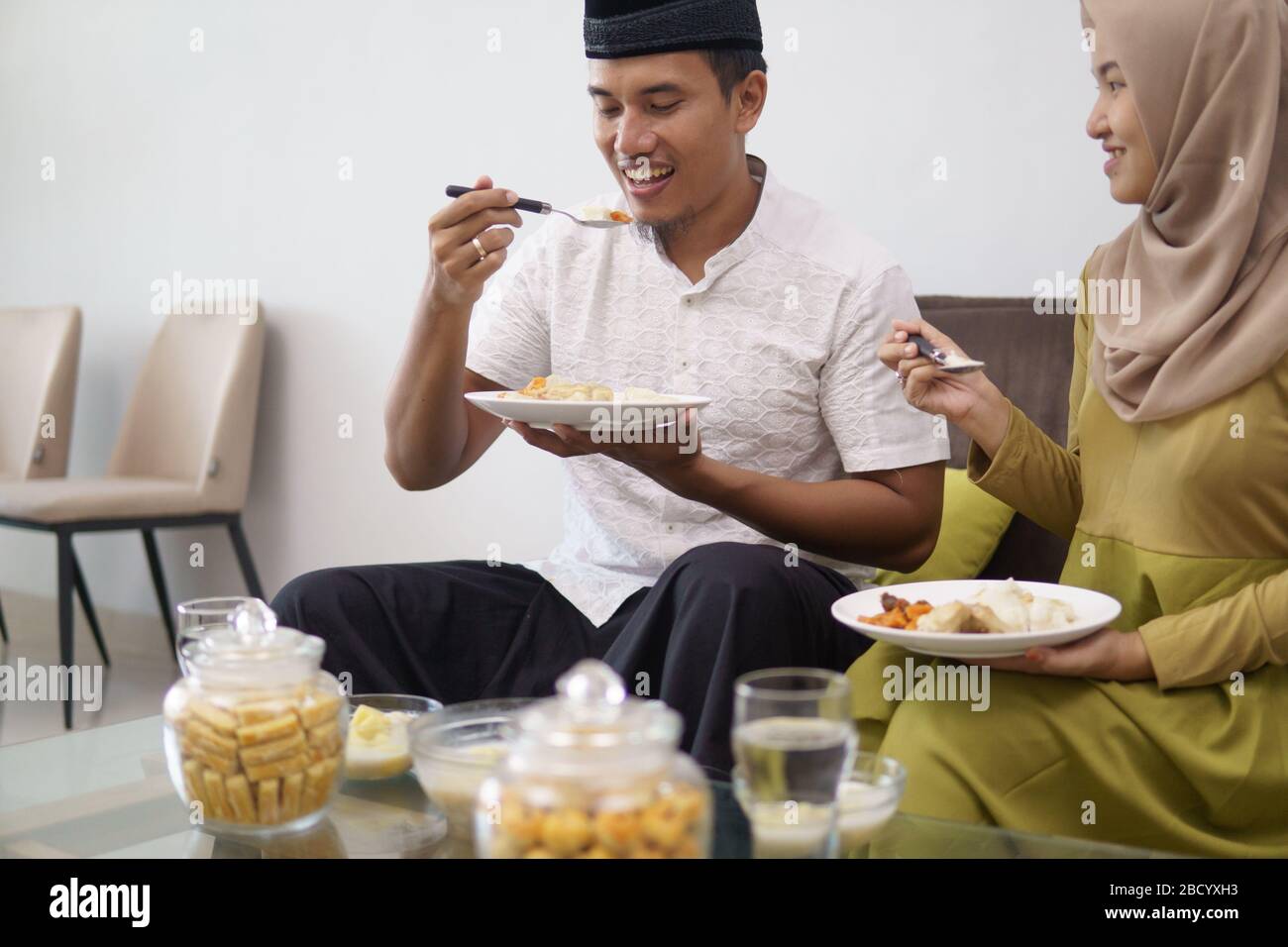 family having early breakfast before dawn. sahoor or sahur on ramadan ...