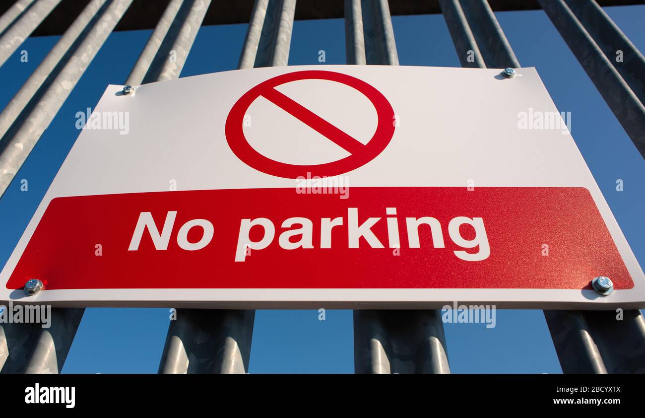 Low angle view of a red & white No Parking sign, attached to a metal ...