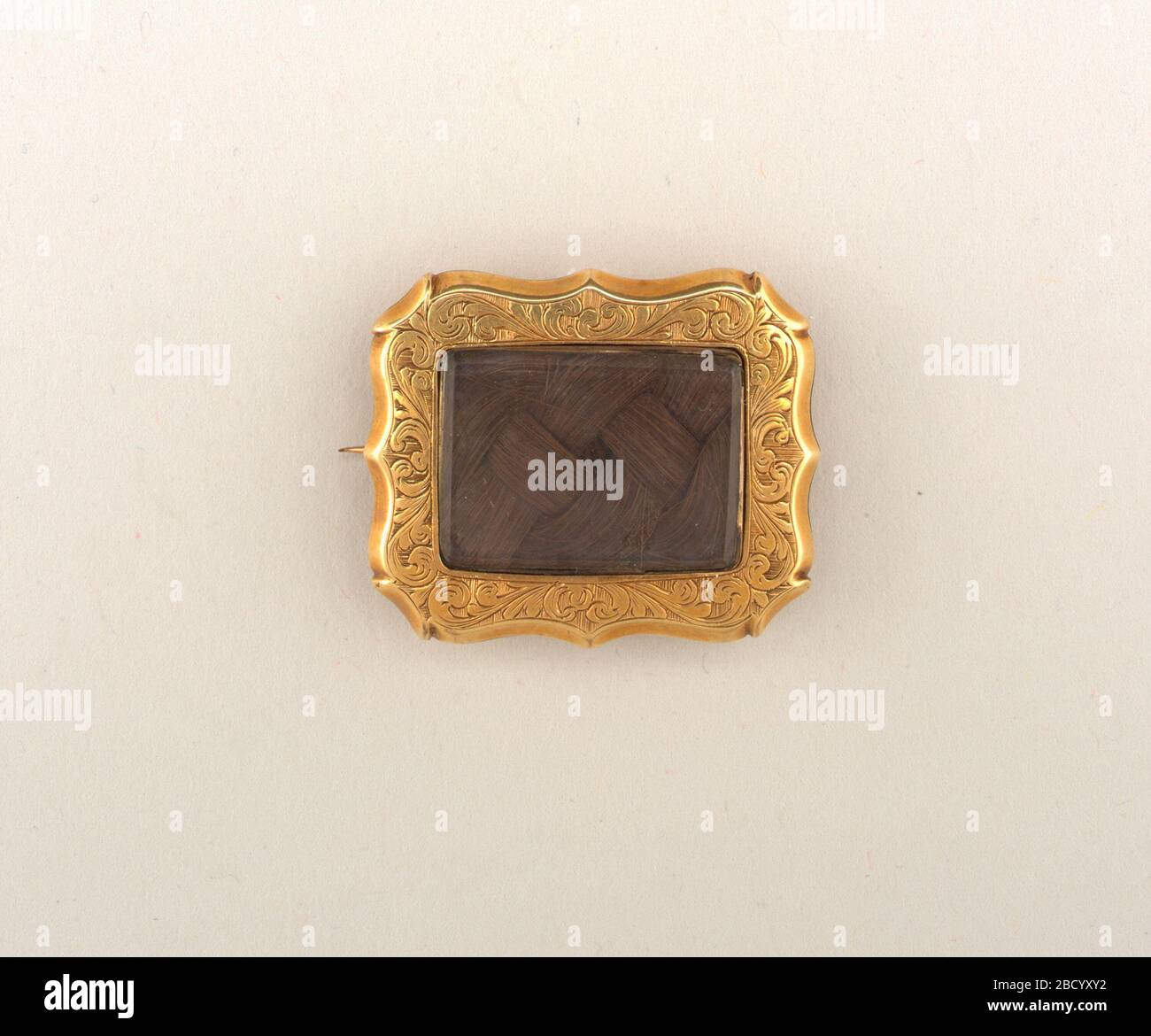 Brooch. Research in ProgressRectangular brooch. Center of woven bundles ...