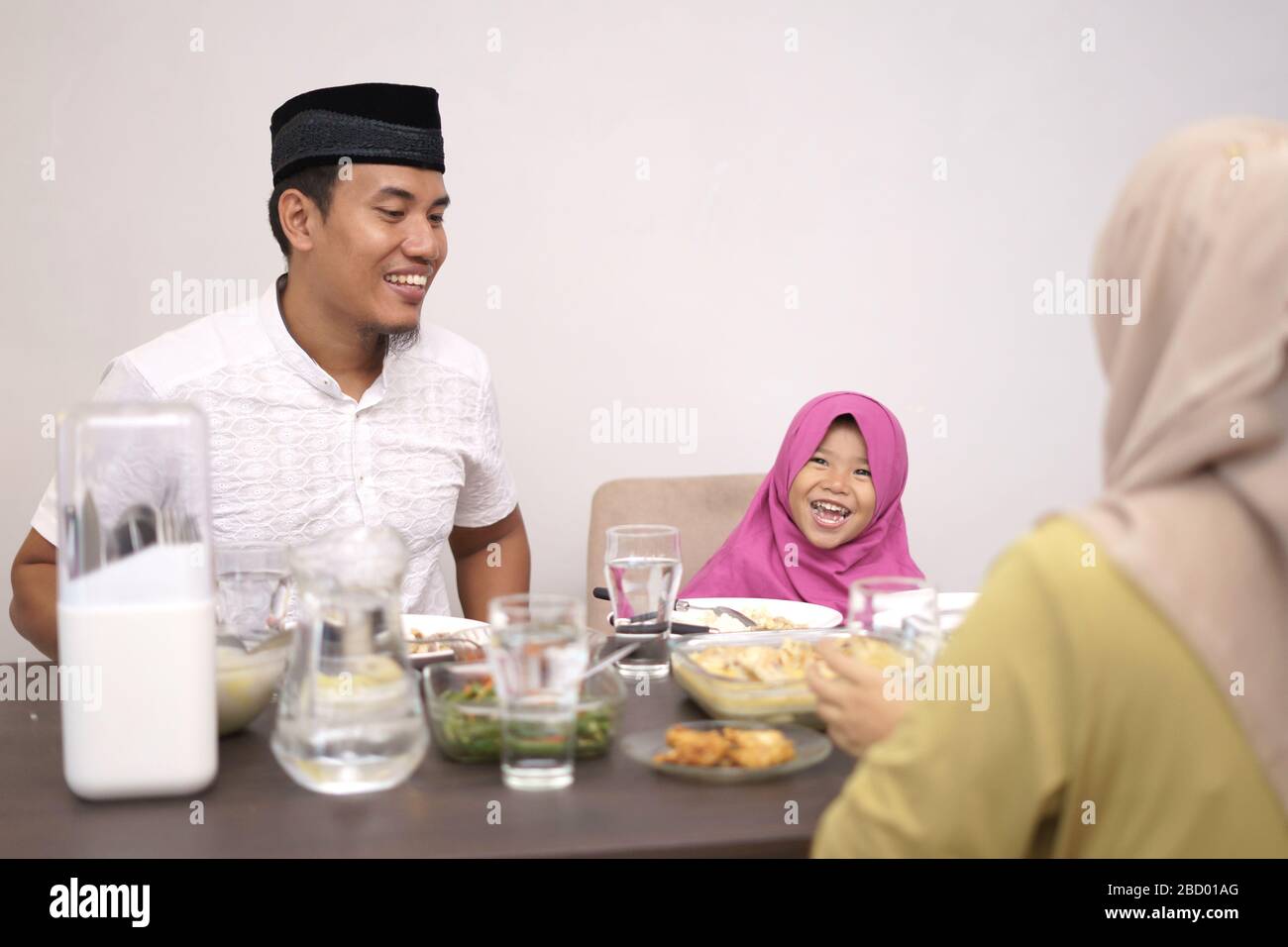family having early breakfast before dawn. sahoor or sahur on ramadan ...