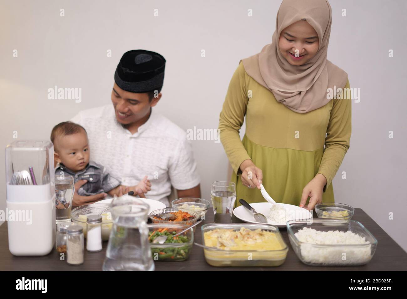 muslim family breaking the fast on ramadan kareem. islam dinner after ...
