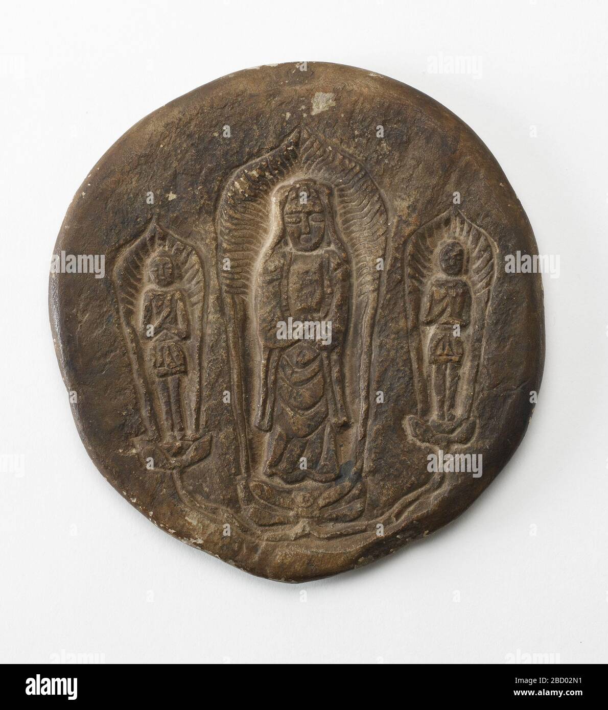 Circular plaque with Buddhist trinity on obverse and brief inscription ...